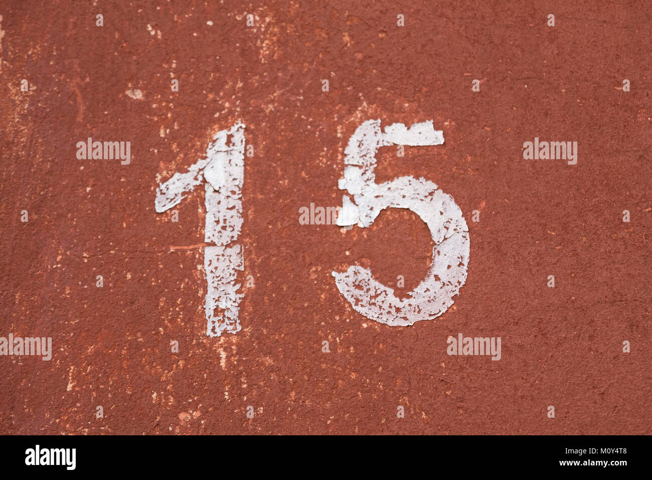 Number fifteen on the old wall of red color Stock Photo - Alamy