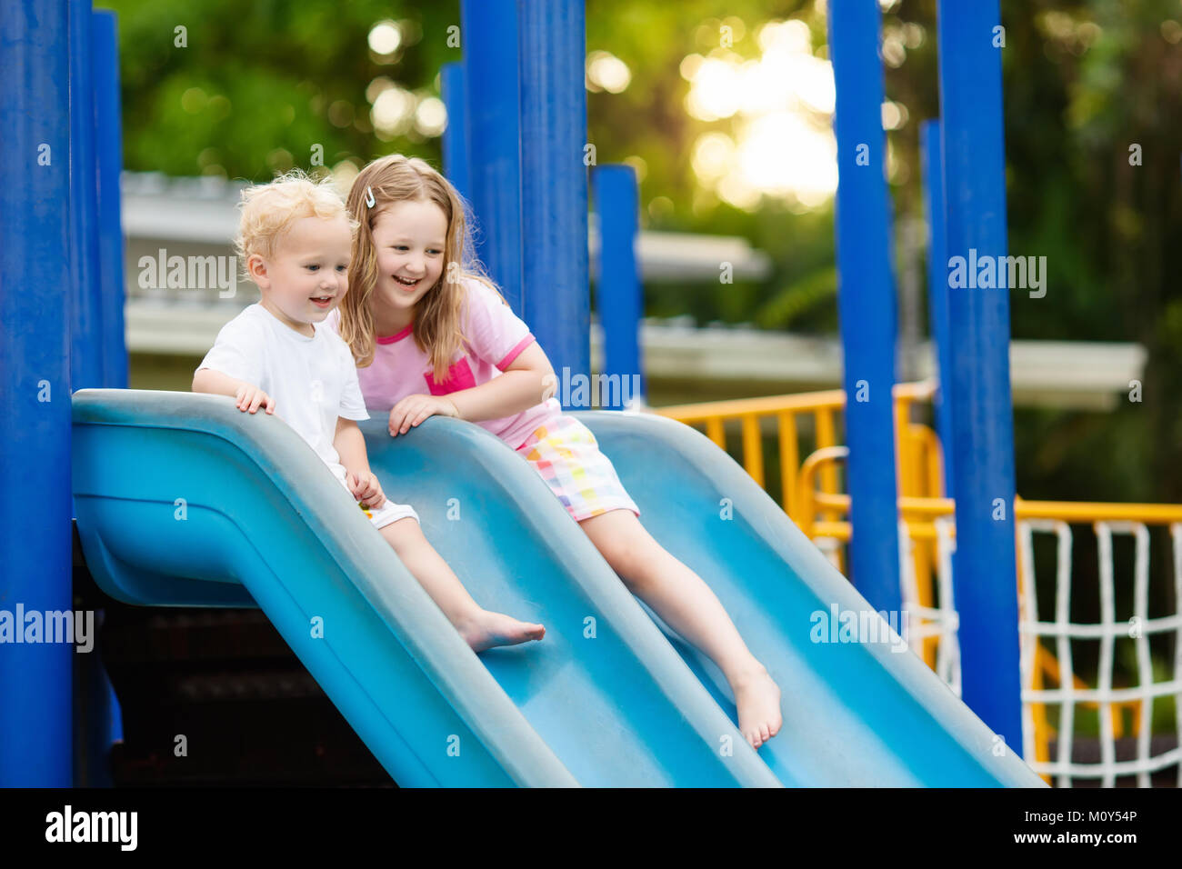 Kids on climbing and sliding on outdoor playground. Children play in ...