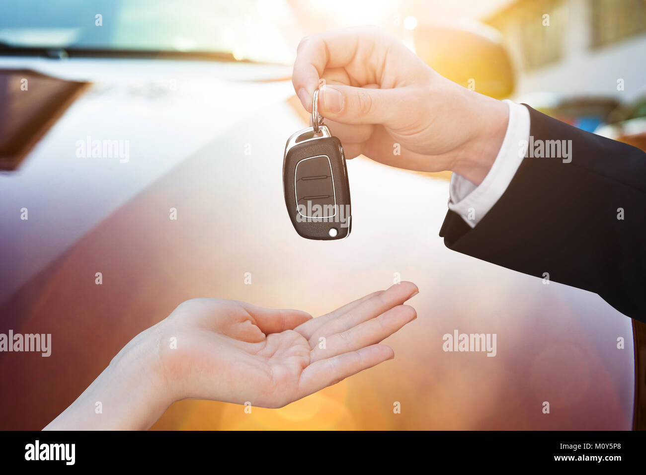Man's Hand Placing The Car's Key On Hand Stock Photo - Alamy