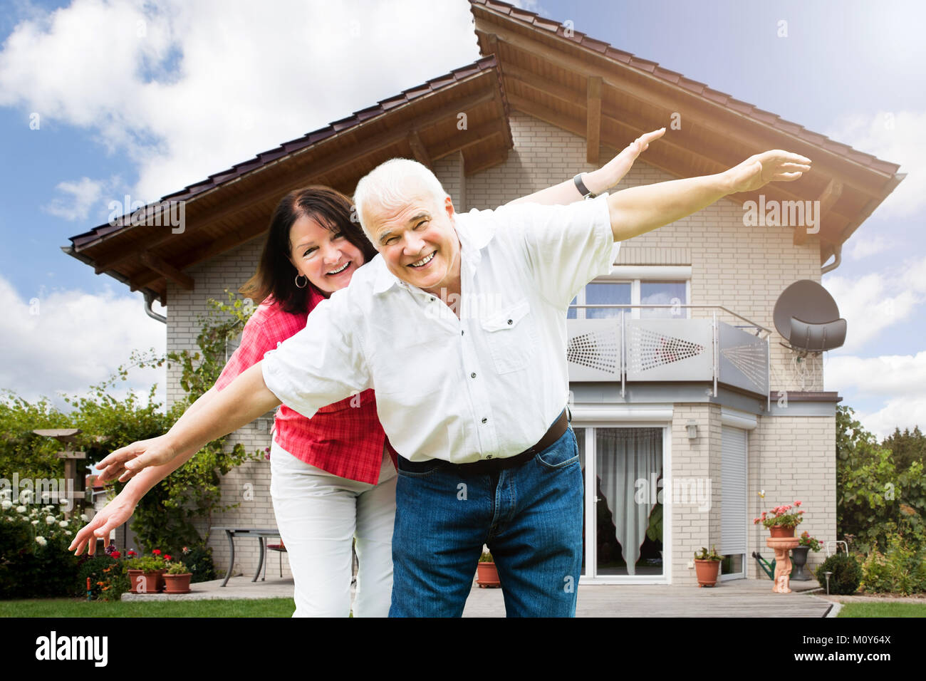 Woman standing front house hi-res stock photography and images - Alamy