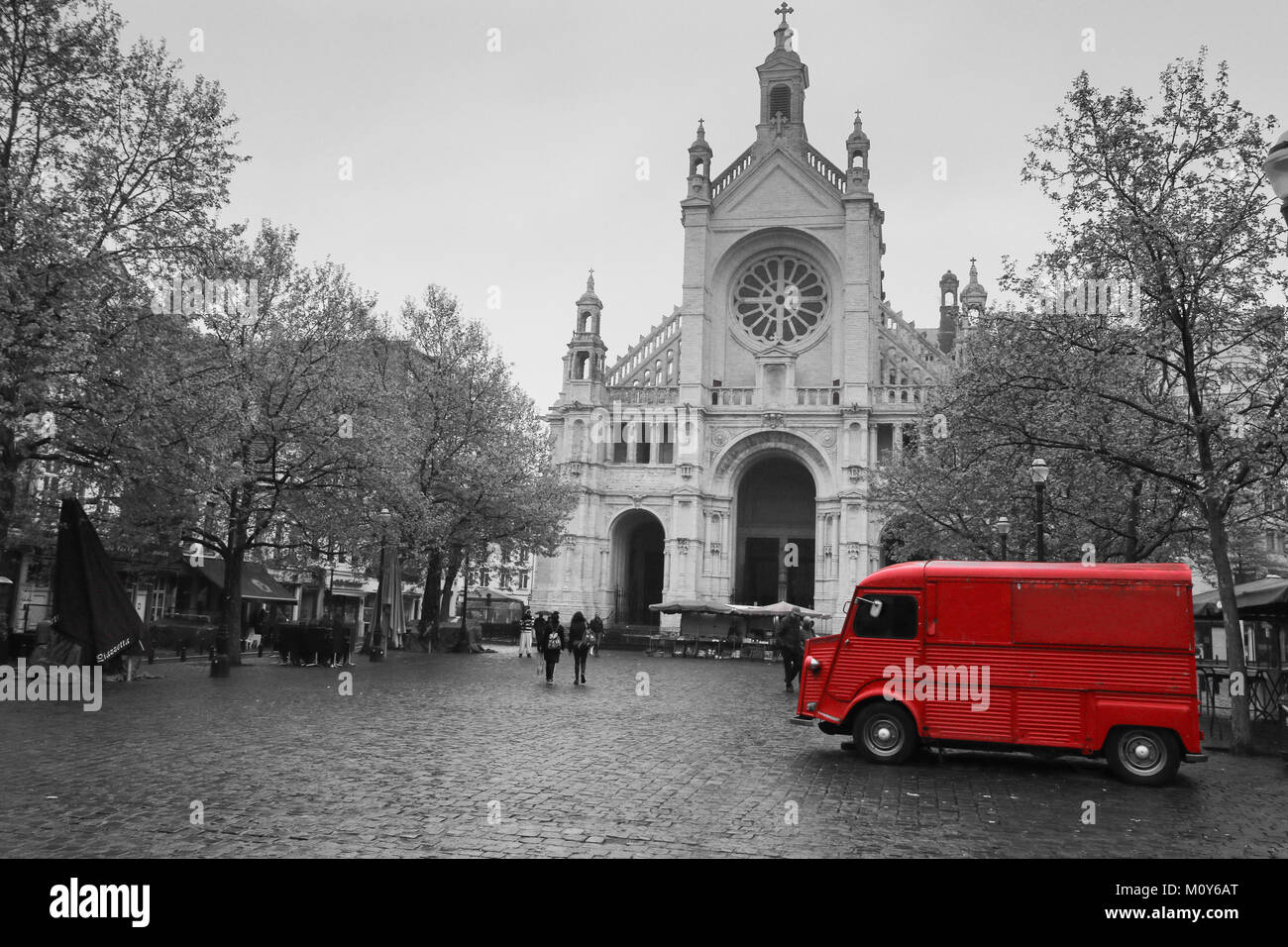 A picture from a square in Brussels. The red old retro van is standing ...