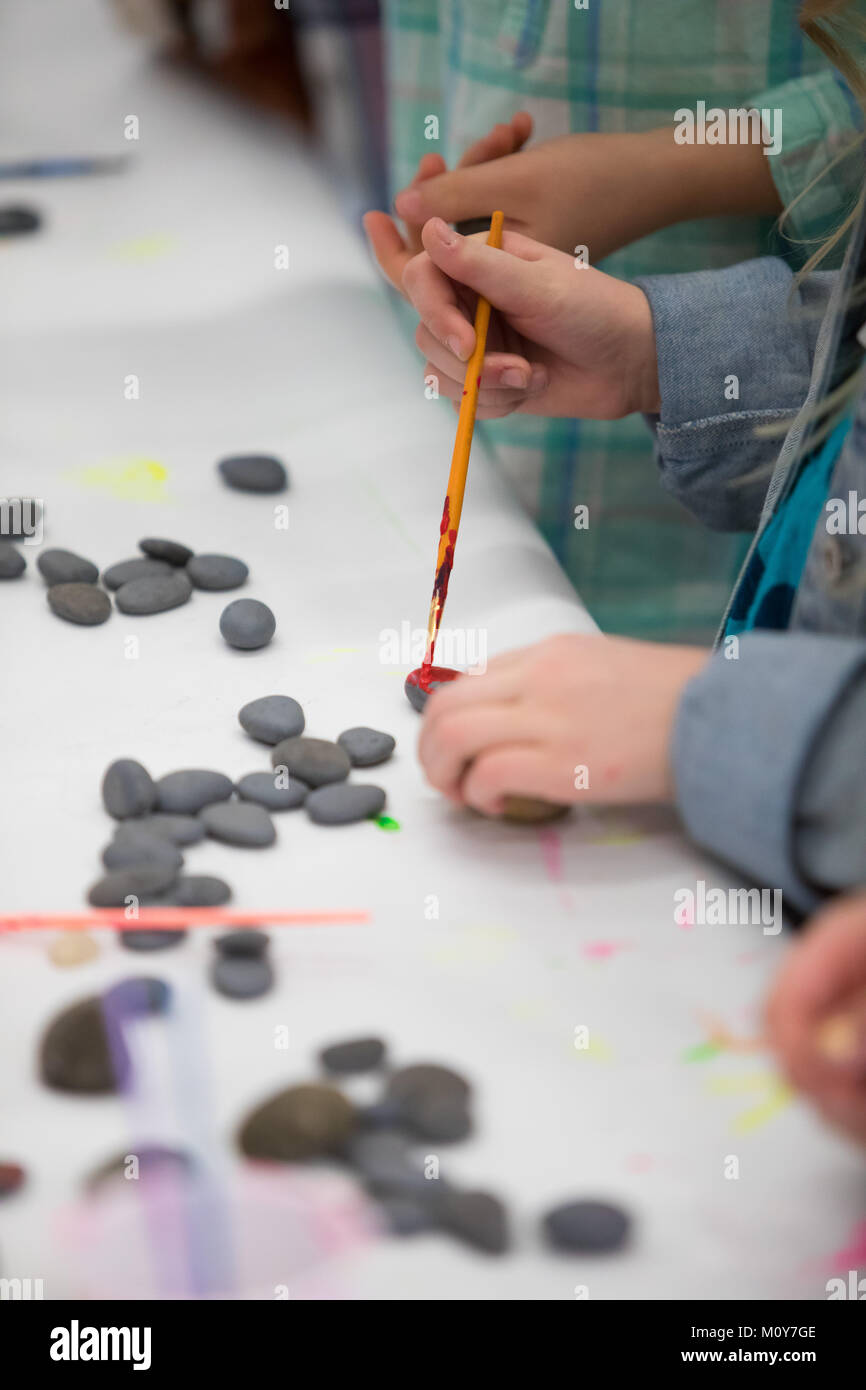 Child Painting Rocks in Class Stock Photo - Alamy