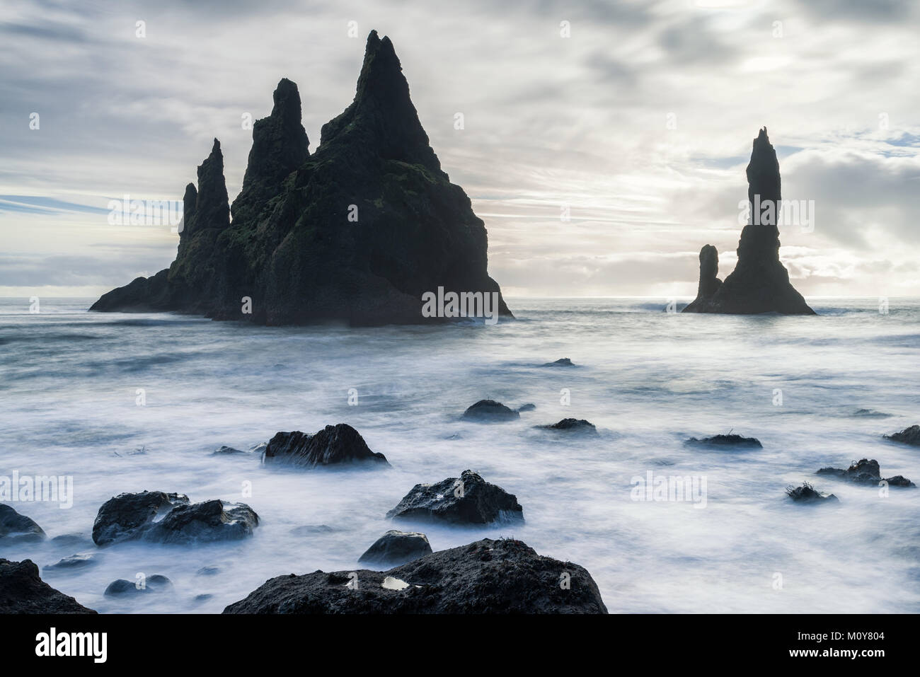 Reynisdranger basalt sea stack columns at Reynisfjara beach partially ...