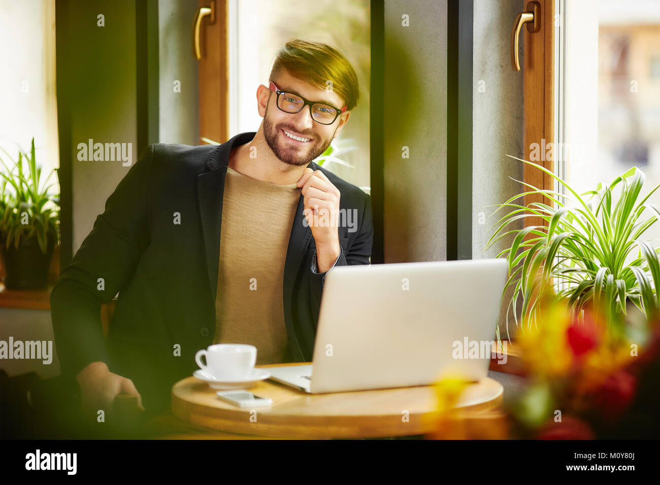 Smiling emotional man at laptop Stock Photo - Alamy