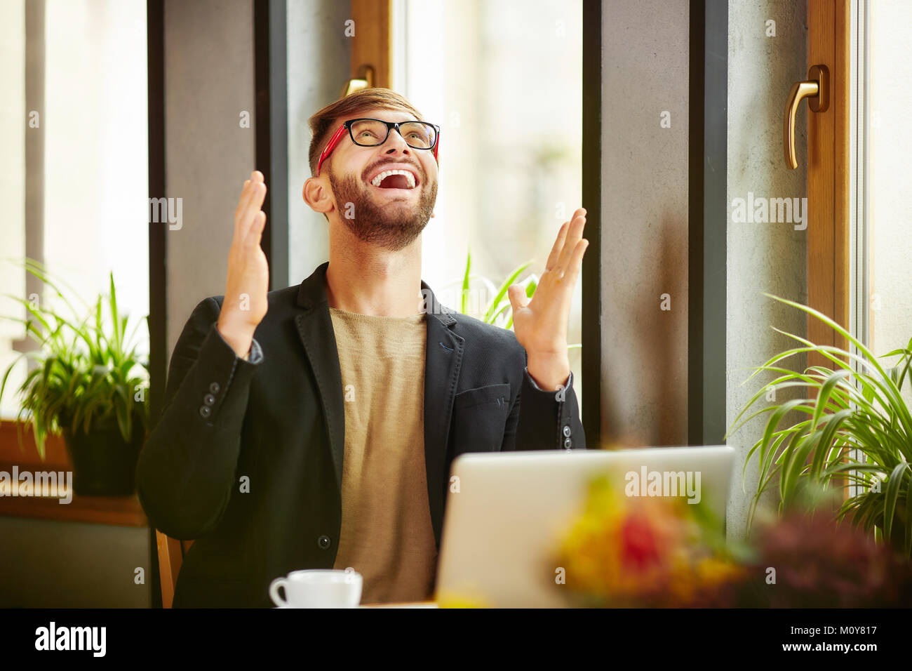Emotional celebrating man at laptop Stock Photo - Alamy