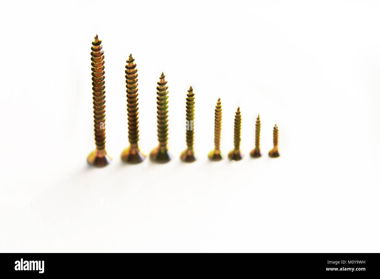 Screws set by a ladder on a white background Stock Photo - Alamy