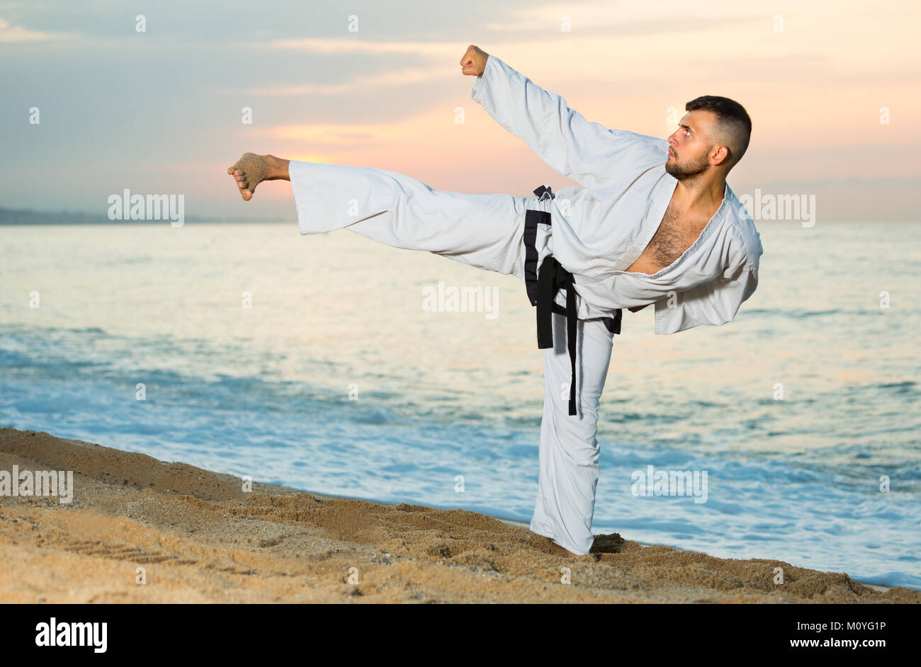 Male is training kick on the beach near the sea Stock Photo - Alamy