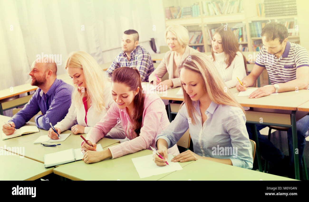 Smiling students of different age at extension courses Stock Photo - Alamy