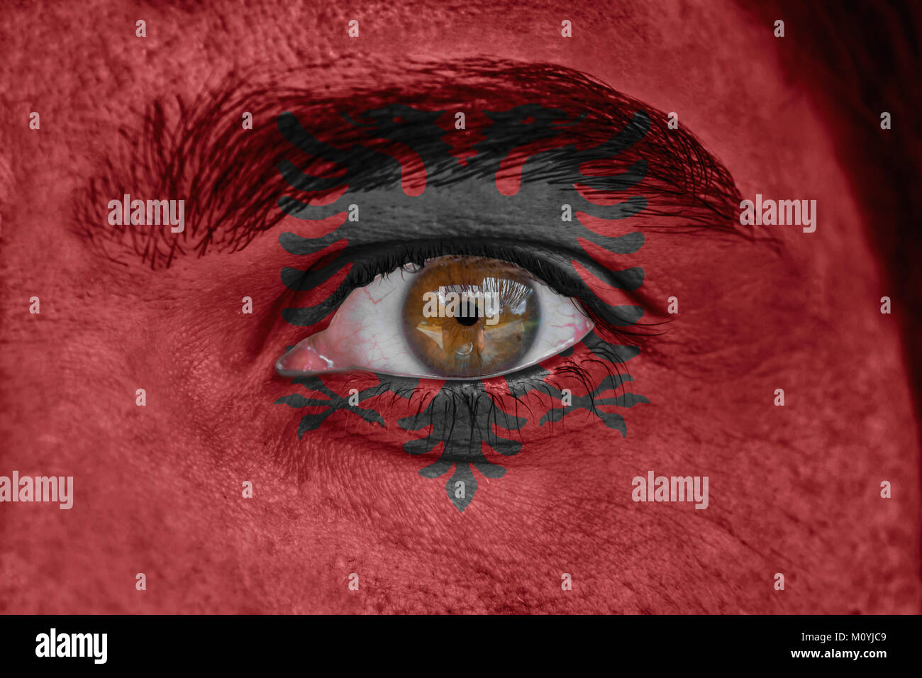 Human face and eye painted with flag of Albania Stock Photo - Alamy