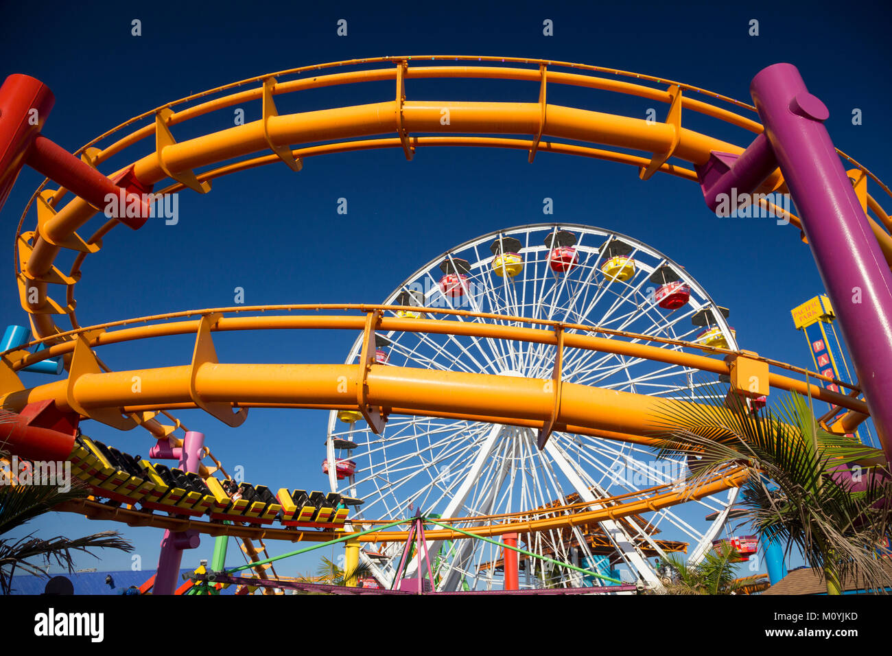 Roller coaster and ferris wheel at Santa Monica Pier, California Stock ...