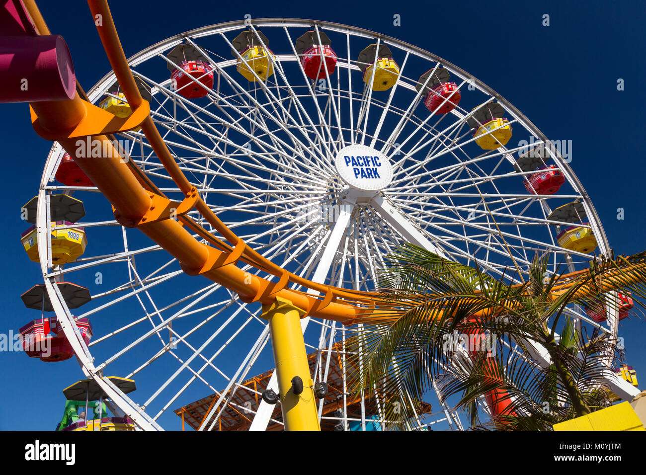 Roller coaster and ferris wheel at Santa Monica Pier, California Stock ...