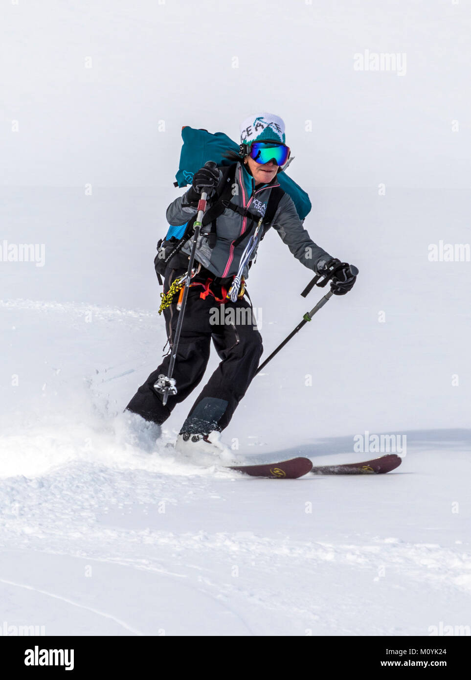 Female alpine ski mountaineer skiing downhill in Antarctica; RongÃ ...