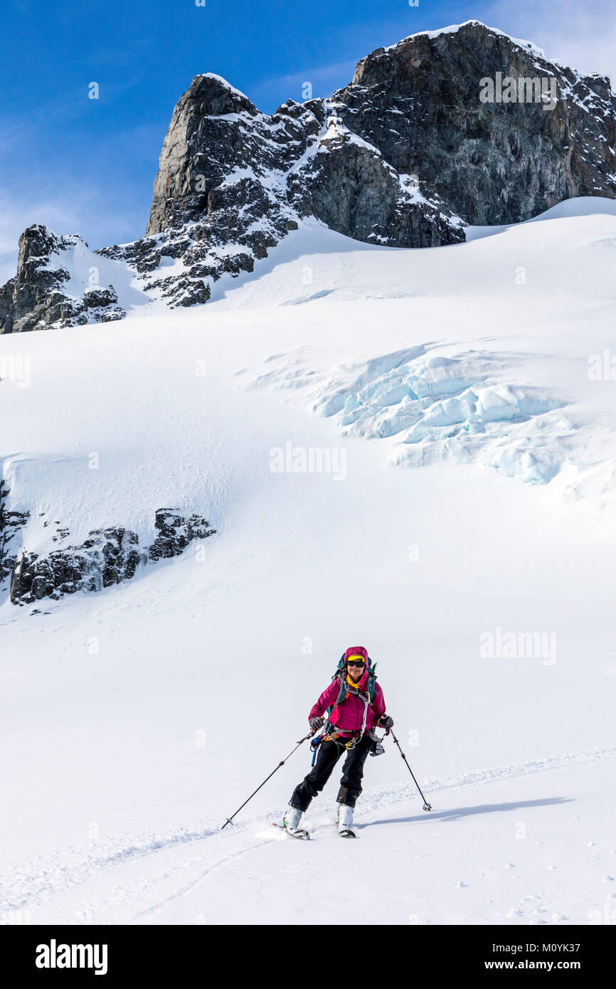 Female alpine ski mountaineer skiing downhill in Antarctica; RongÃ ...