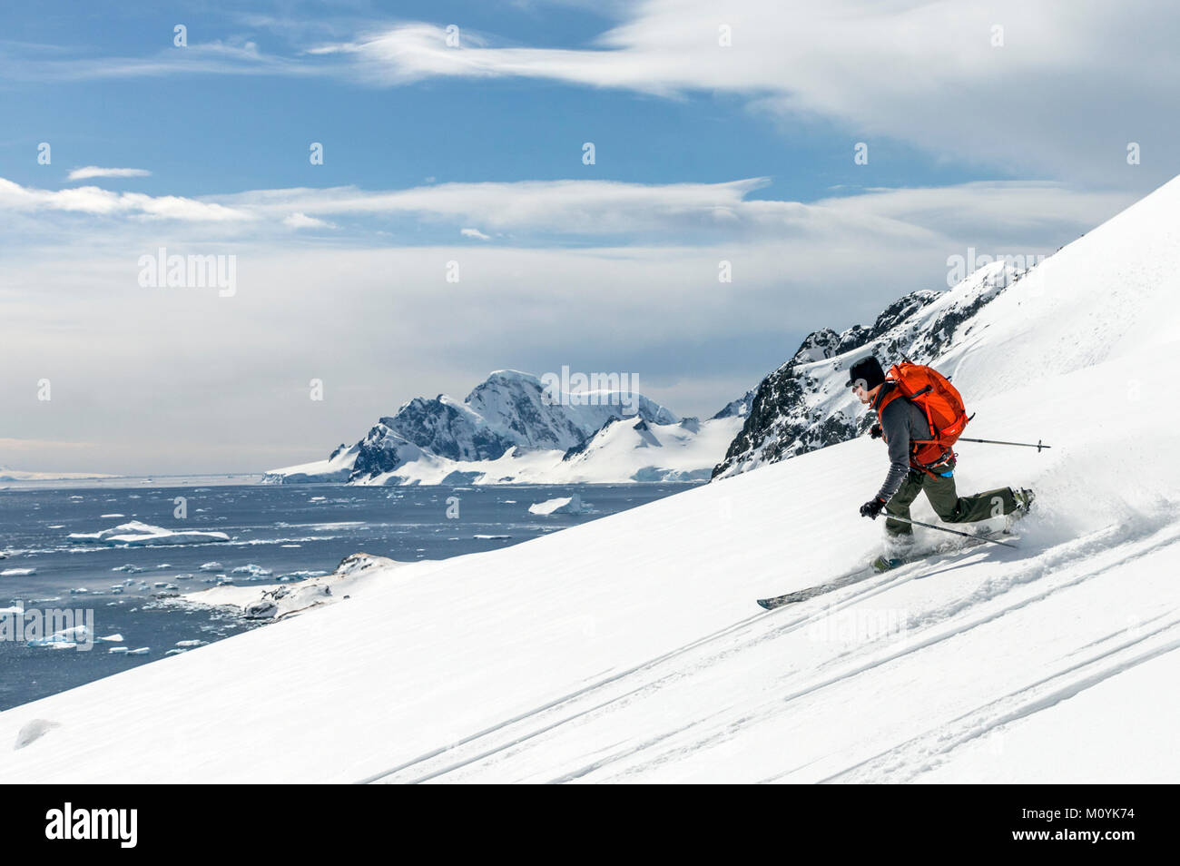 Alpine telemark ski mountaineer skiing downhill in Antarctica; RongÃ ...