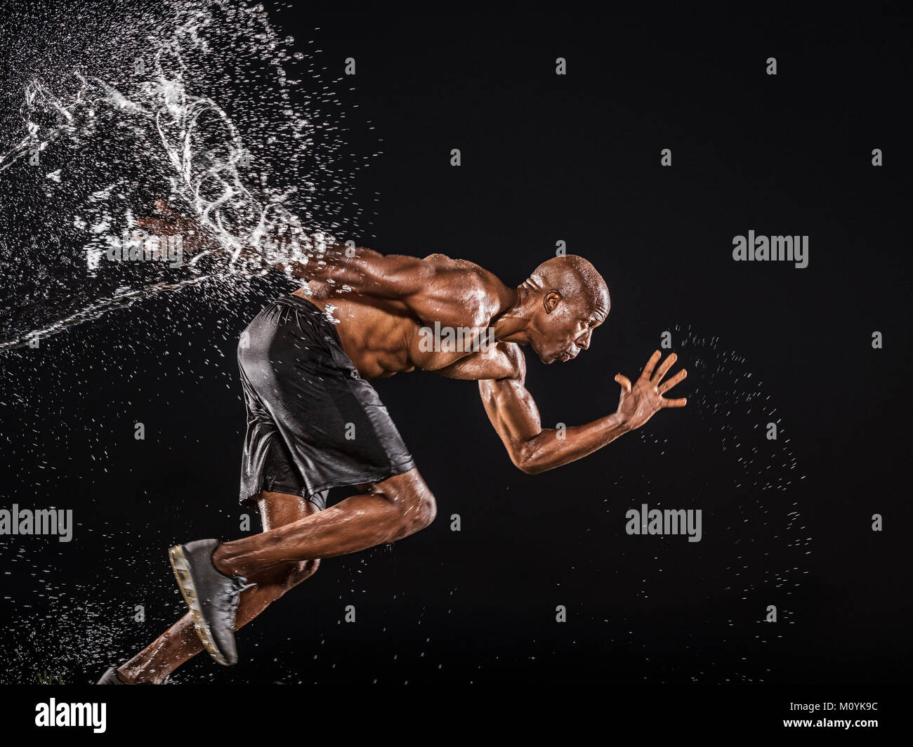 Water splashing on black runner Stock Photo - Alamy