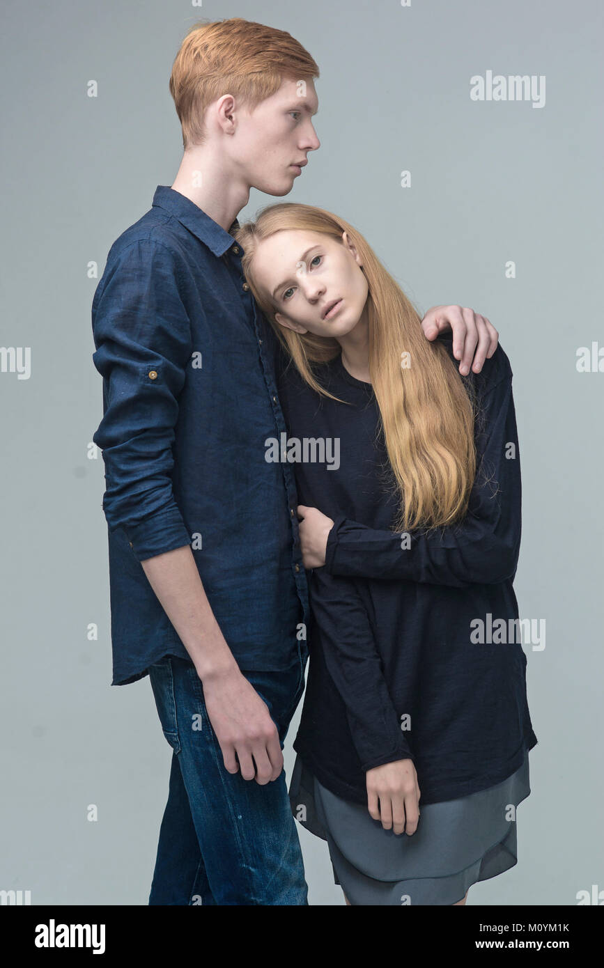 Portrait of serious Caucasian couple hugging Stock Photo - Alamy