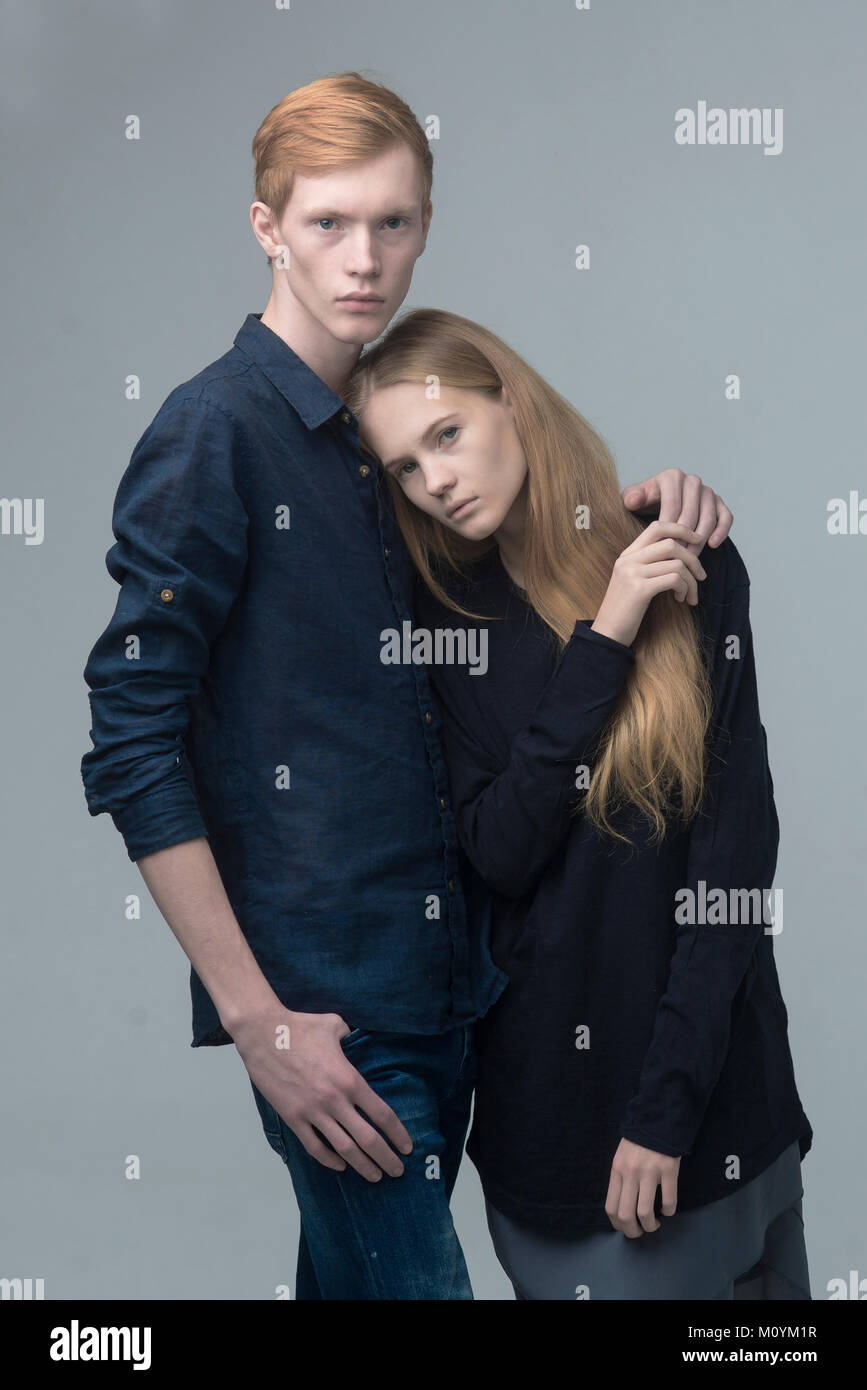 Portrait of serious Caucasian couple hugging Stock Photo - Alamy