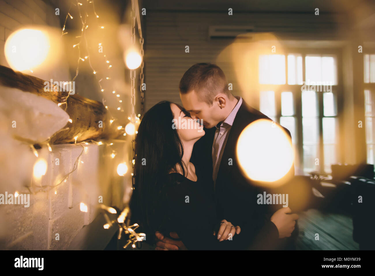 Caucasian couple kissing near wall Stock Photo - Alamy
