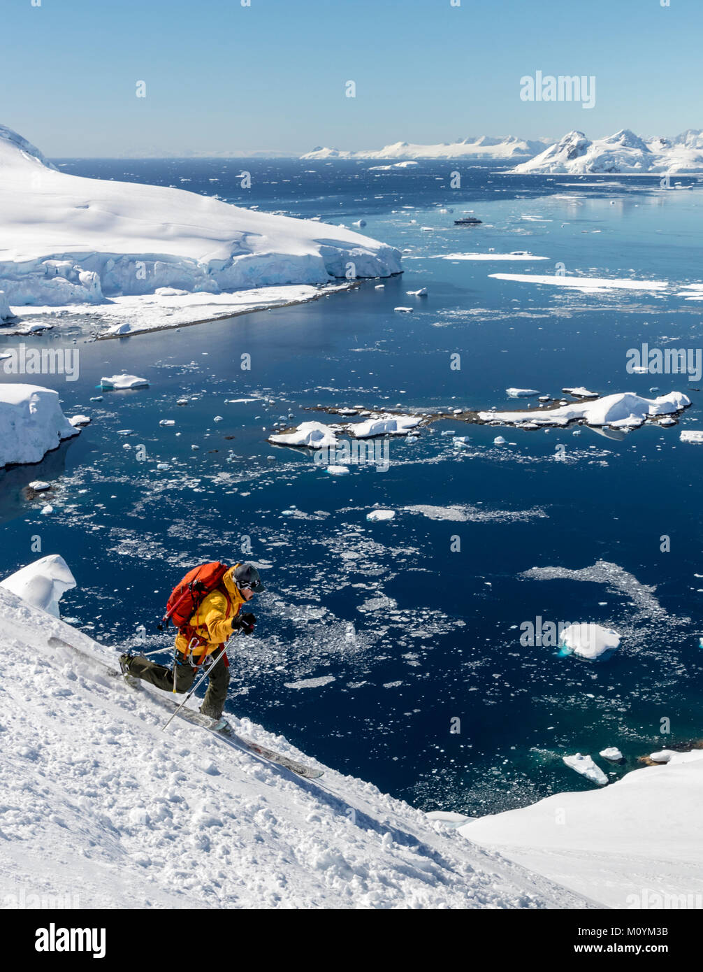 Alpine telemark ski mountaineer skiing downhill in Antarctica; Nansen ...