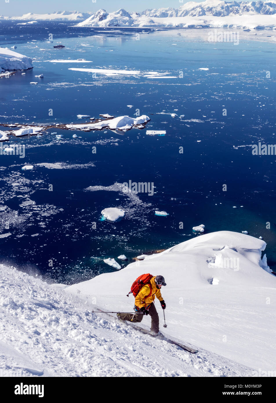 Alpine telemark ski mountaineer skiing downhill in Antarctica; Nansen ...