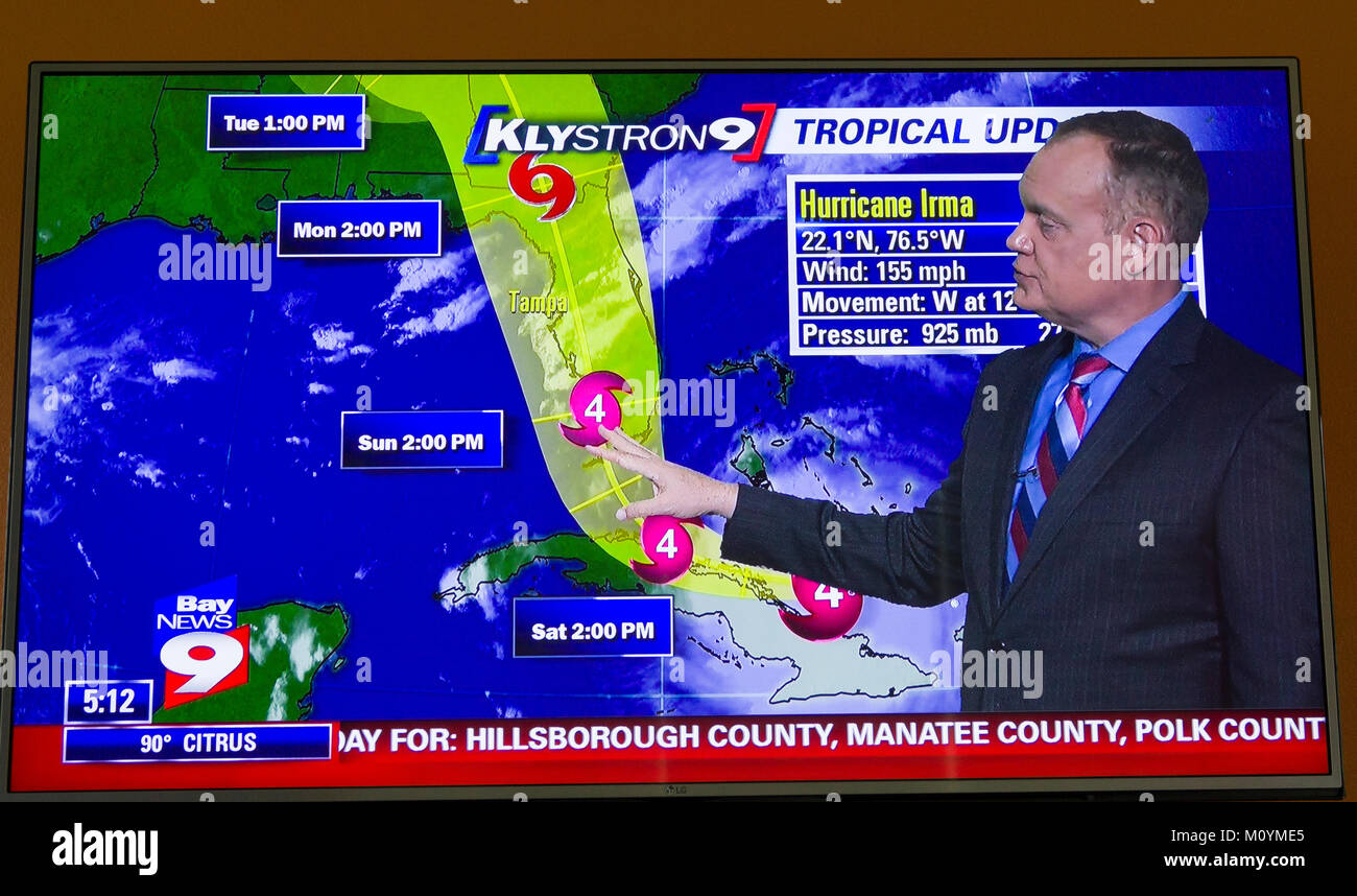 Following and tracking a hurricane Irma warning on tv television and a ...