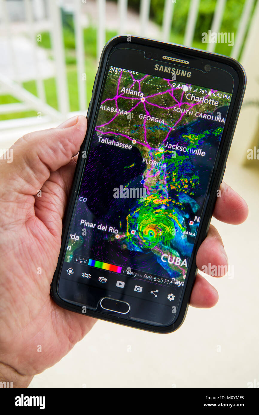 Following and tracking a hurricane Irma warning on tv television and a ...