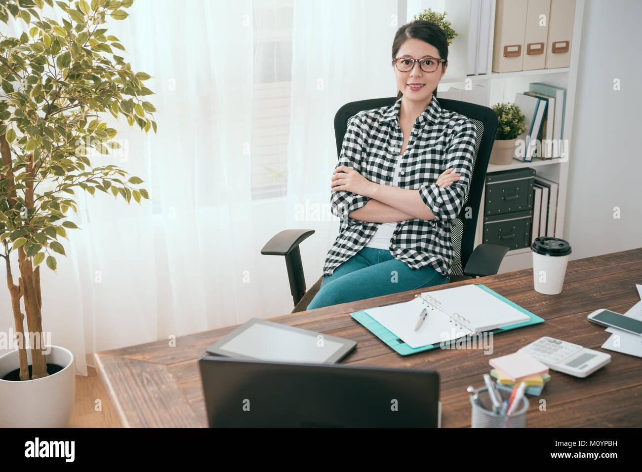 smiling beauty soho girl worker hands crossed sitting on studio ...