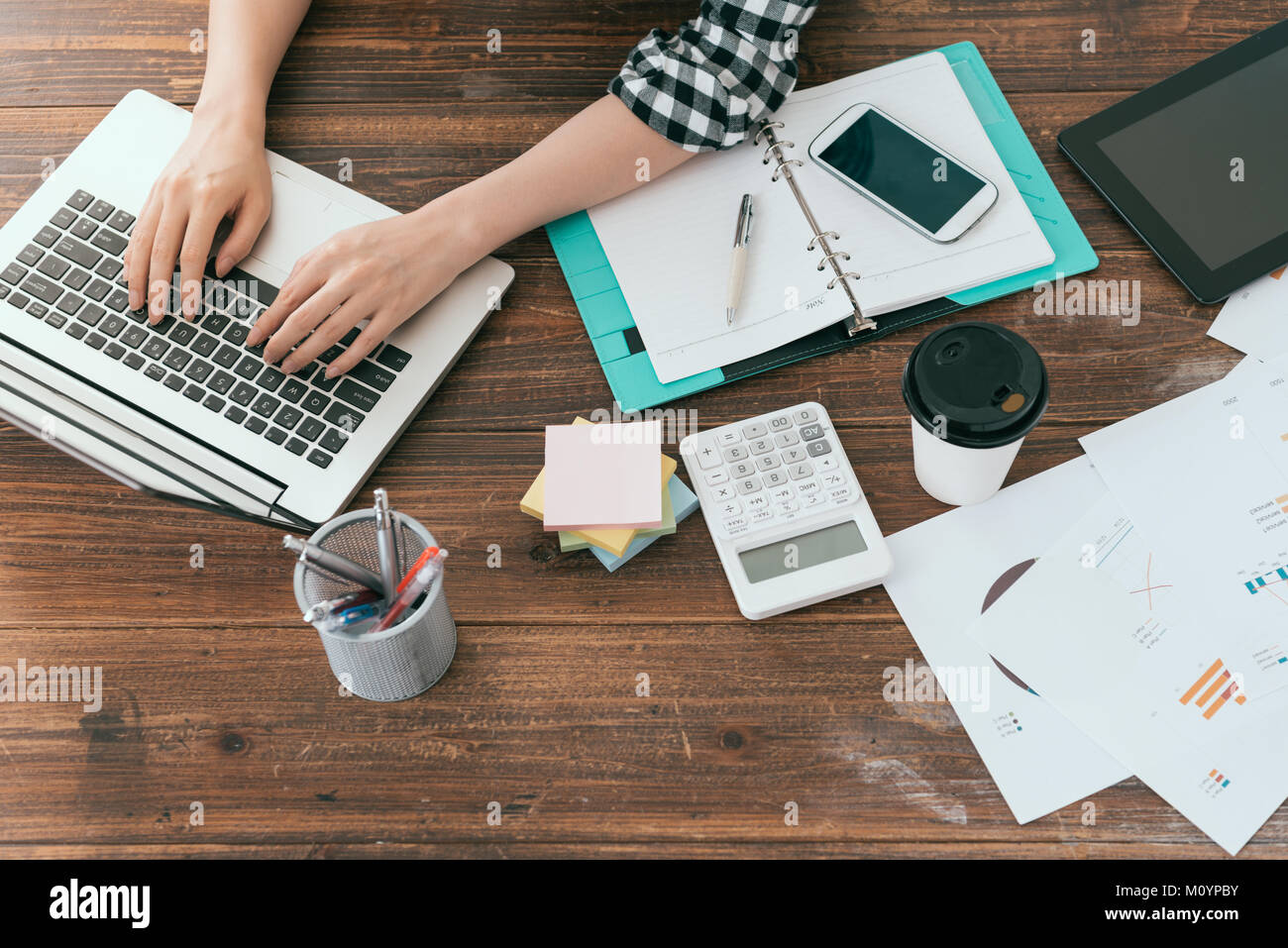 closeup of business woman using mobile laptop working with high angle ...