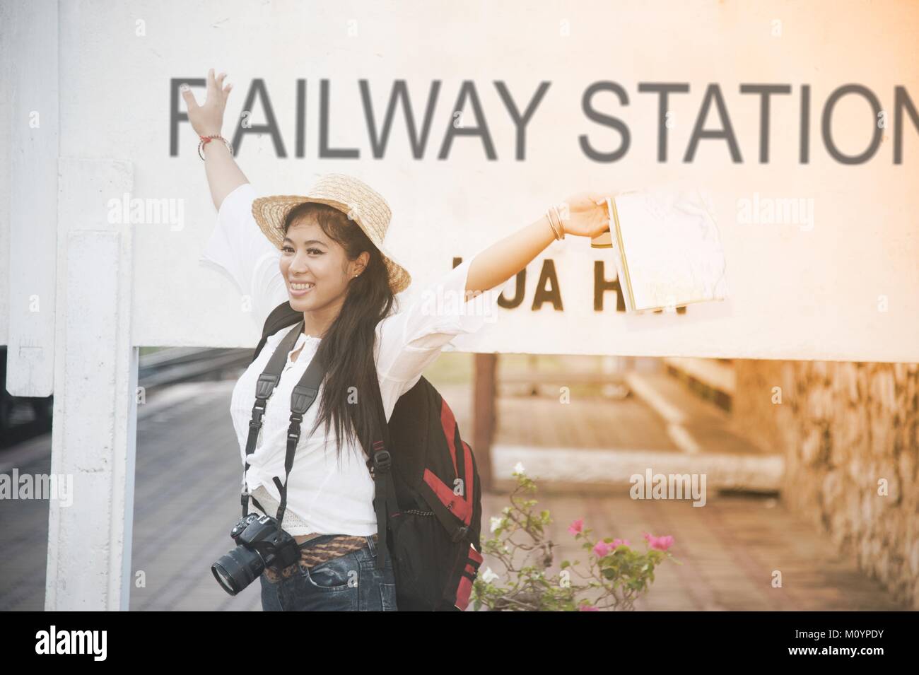 Pretty Asian female traveler joyful and waiting train at railway ...