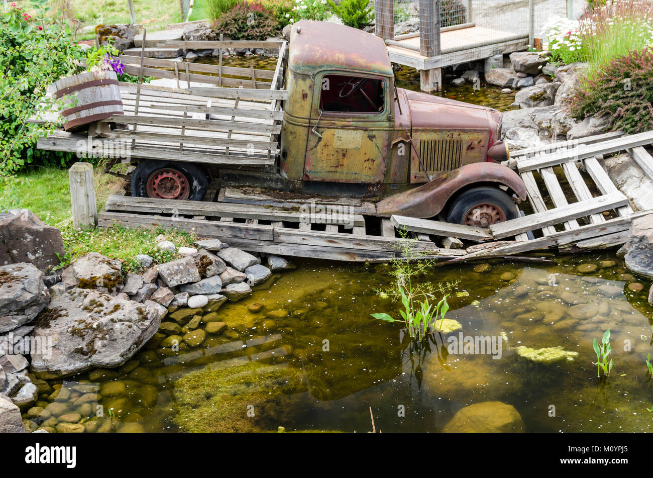 Vintage delivery truck used as a prop in a landscaped garden Stock ...