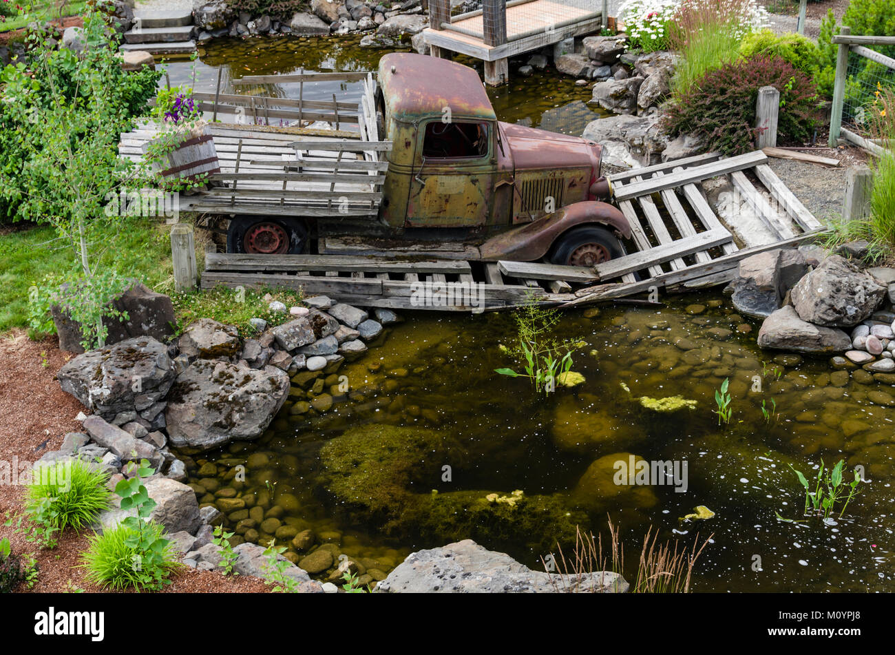 Vintage delivery truck used as a prop in a landscaped garden Stock ...