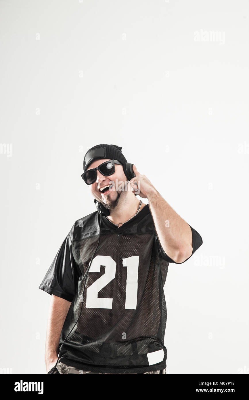 emotional and charismatic DJ - rapper with headphones on a light Stock ...