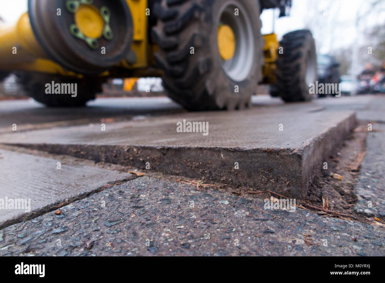 A pavement flagstone / concrete flag which has moved under the weight ...