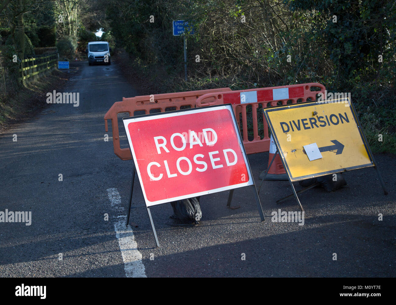 Road closed signs after storm damage tree fallen blocking road ...