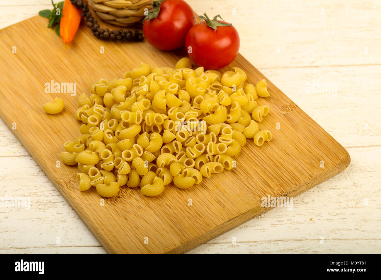 Raw pasta ready for cooking over the wooden background Stock Photo - Alamy