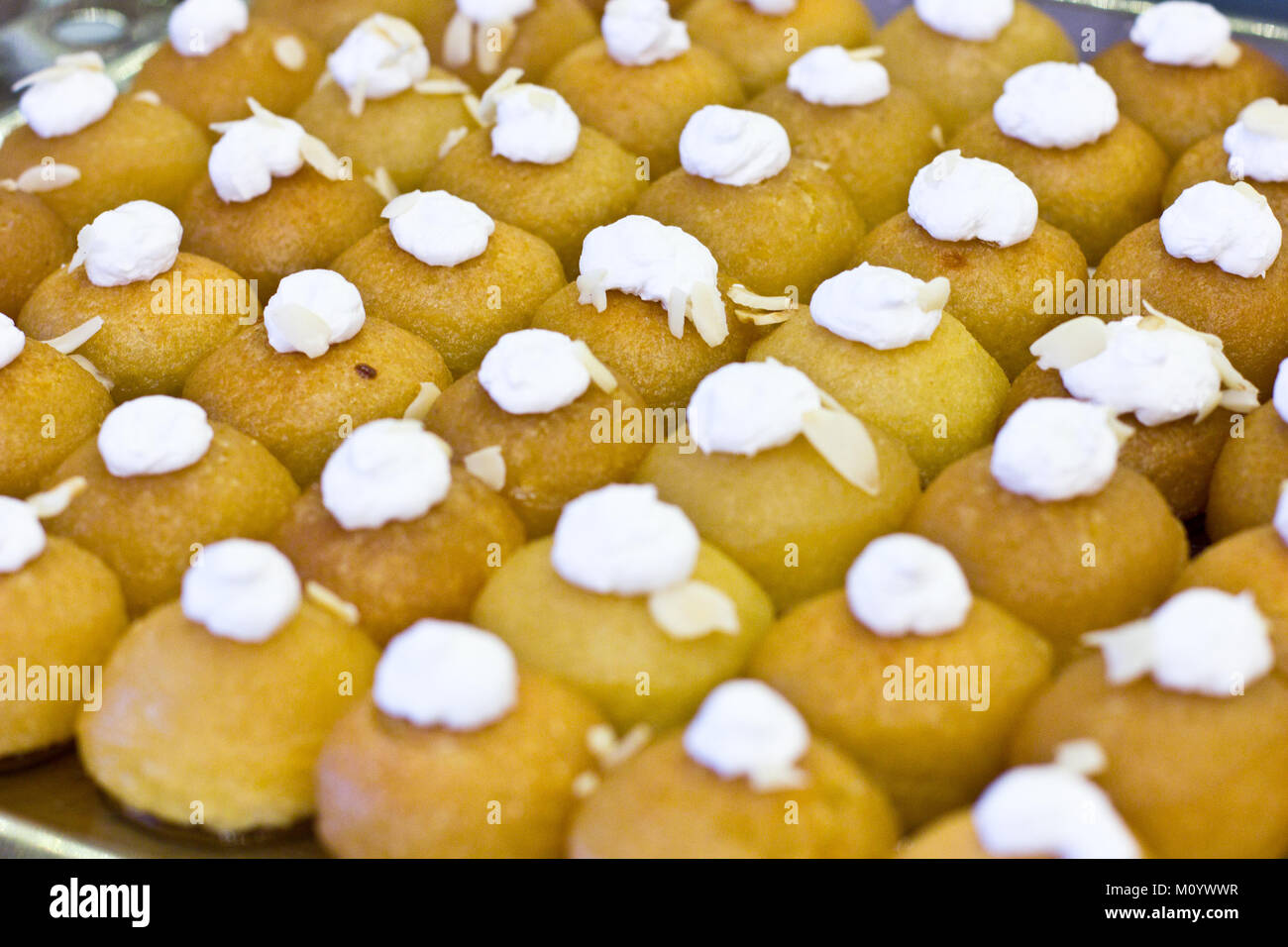 Traditional Turkish dessert Shekerpare with whipped cream. Sliced ...