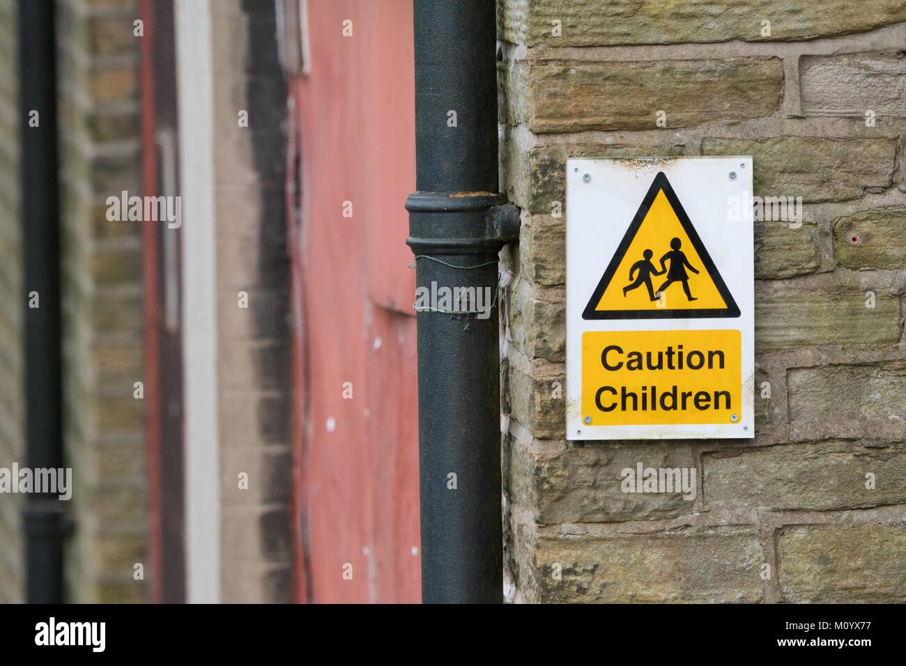 A sign warning of the presence of children on a wall in New Mills ...