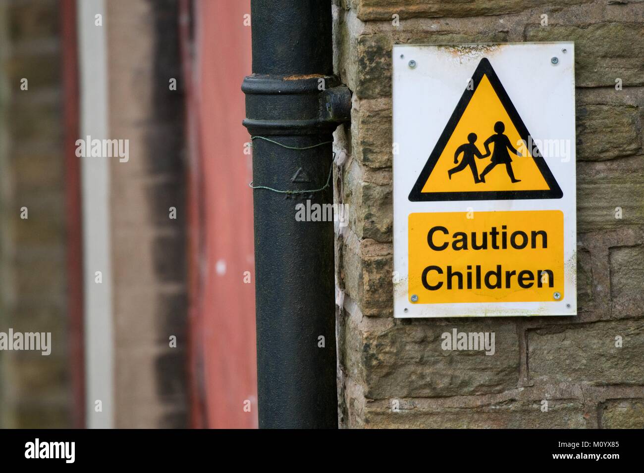 A sign warning of the presence of children on a wall in New Mills ...