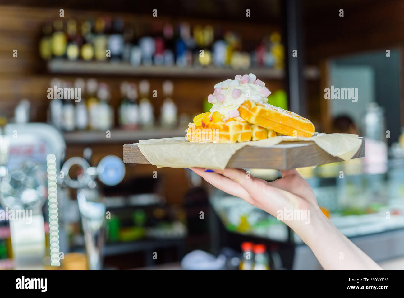 Close up hand holds Belgian waffles on tray Stock Photo - Alamy