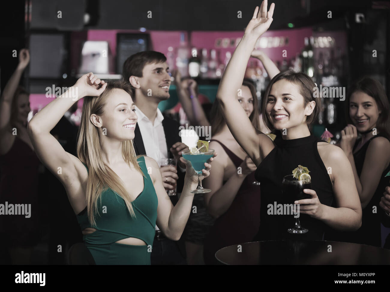 Colleagues dancing on corporate party with alcohol in hands Stock Photo ...