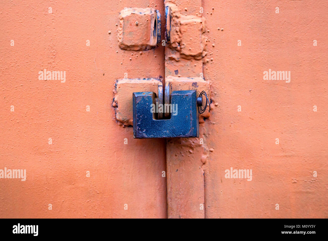 Old metal lock on pink garage door close Stock Photo - Alamy
