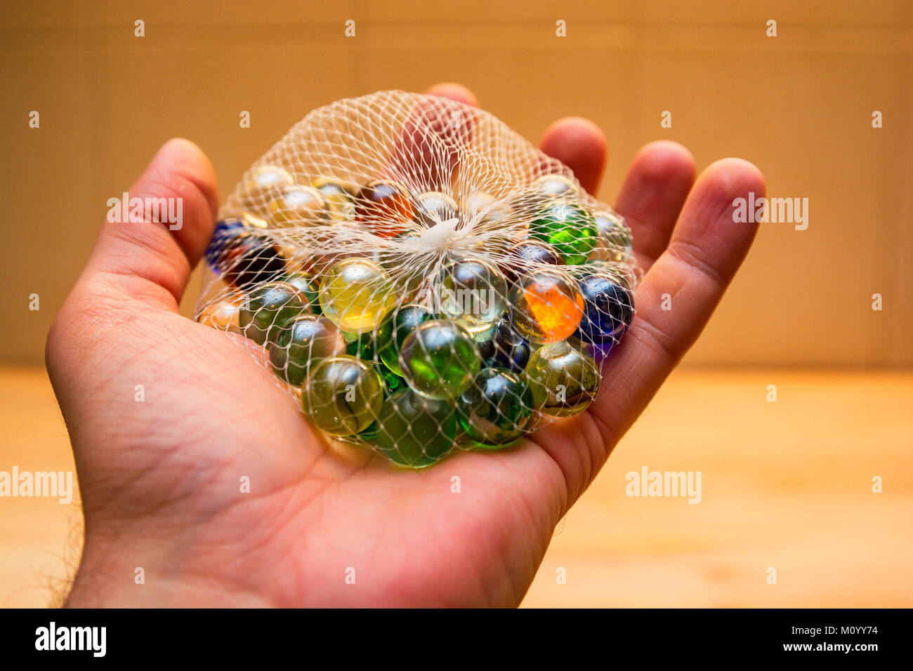 Glass marbles in hand hi-res stock photography and images - Alamy