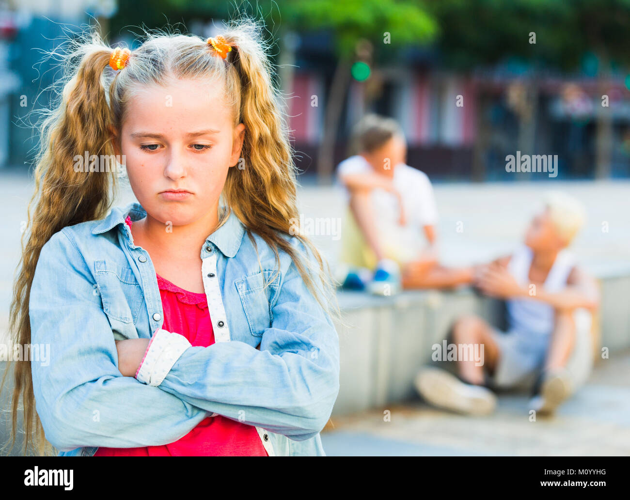 Portrait of sad girl standing apart having problems in relationship ...