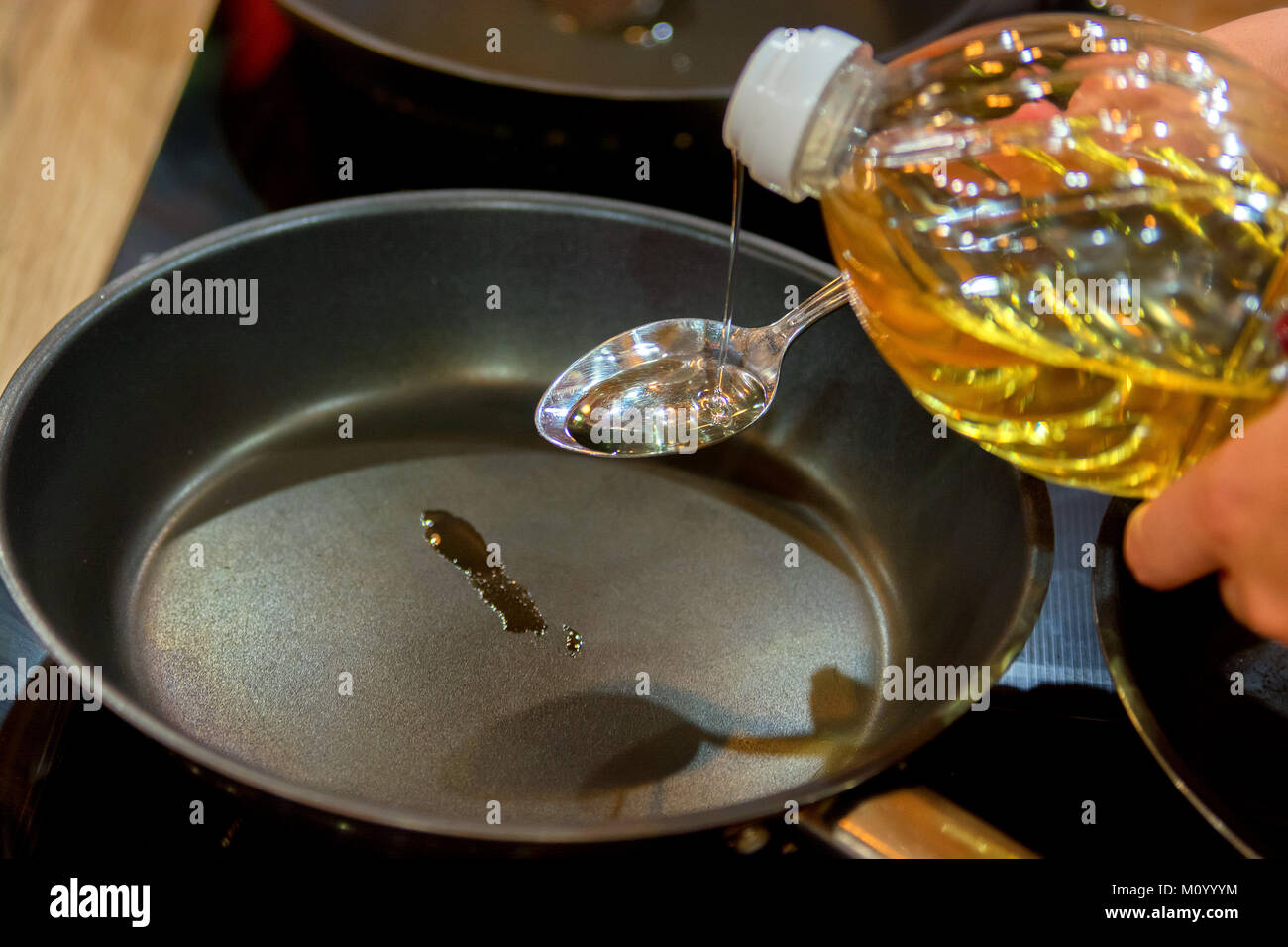 Pouring oil in skillet High Resolution Stock Photography and Images - Alamy