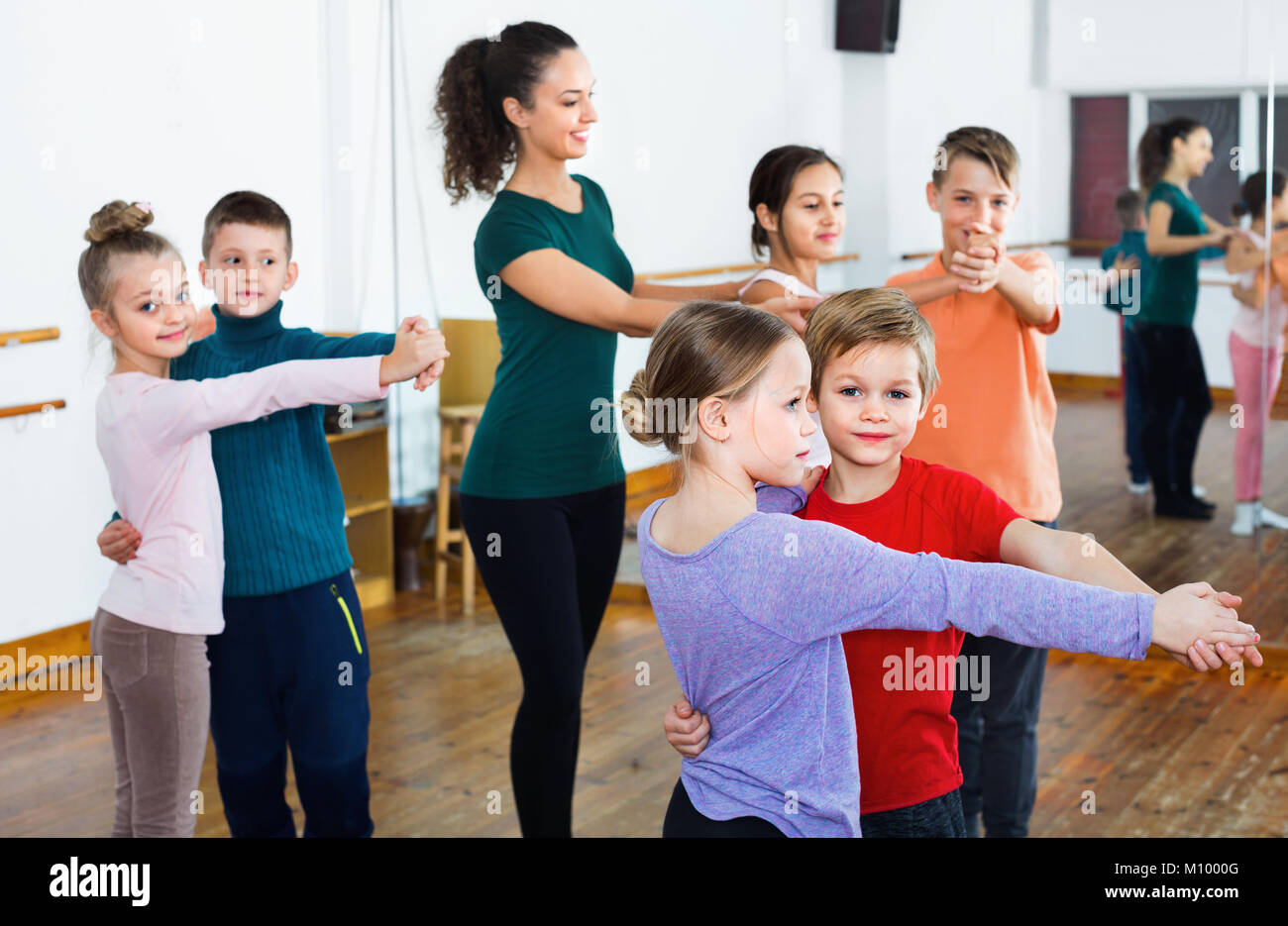 Happy positive children studying of partner dance at dance school Stock ...