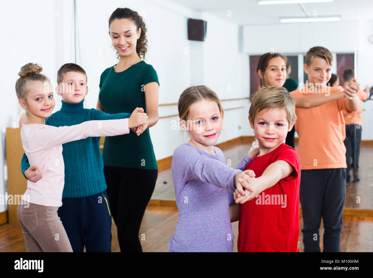 portrait of positive children dancing tango in dance studio Stock Photo ...