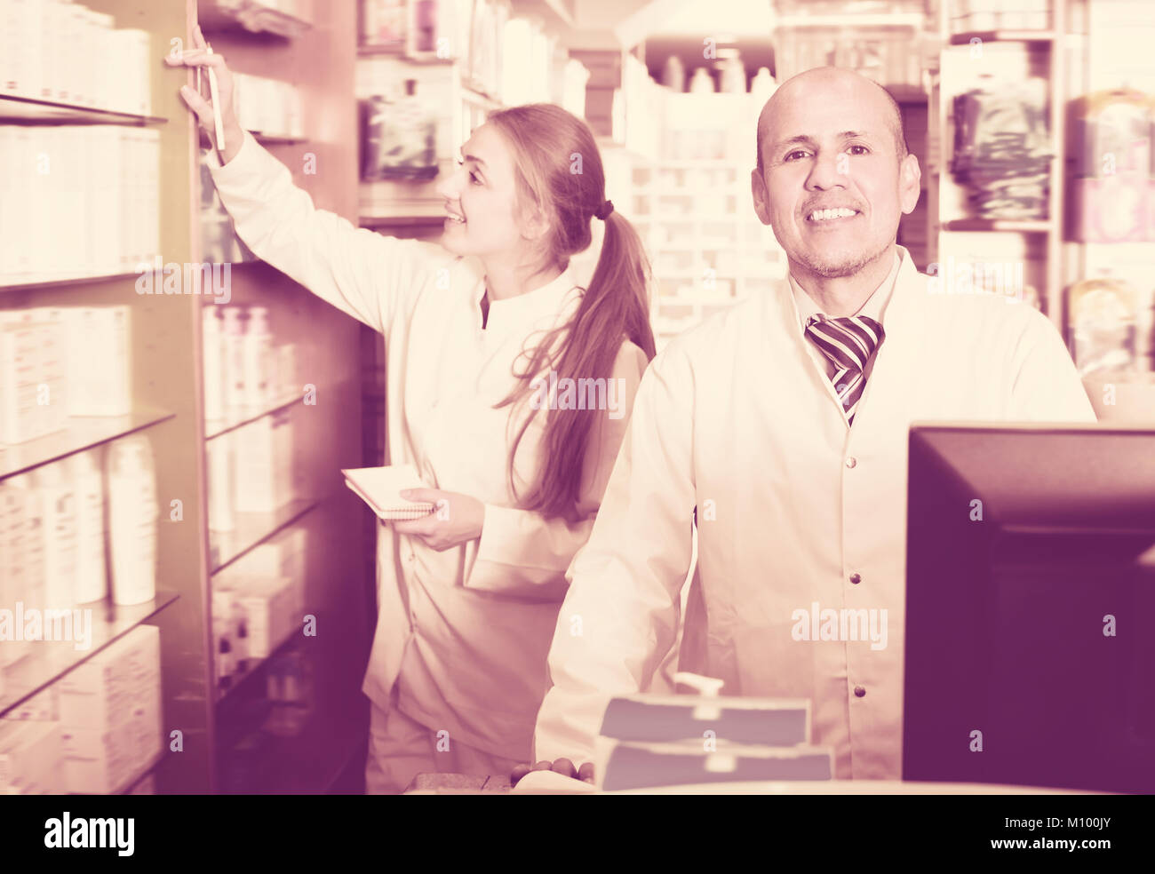 Happy pharmacist and pharmacy technician helping in drugstore Stock ...