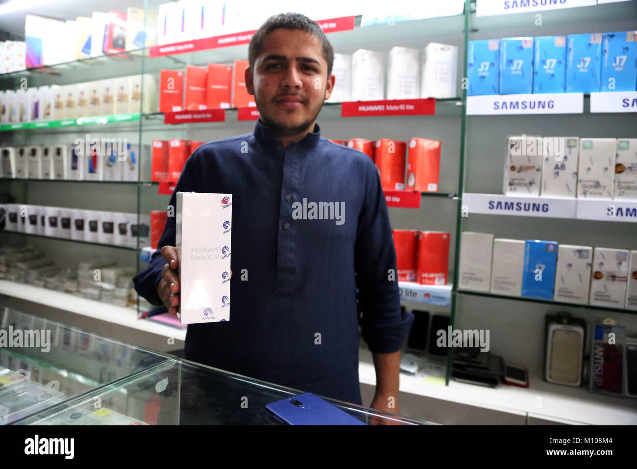Islamabad. 25th Jan, 2018. A shopkeeper shows a Huawei mobile phone at ...