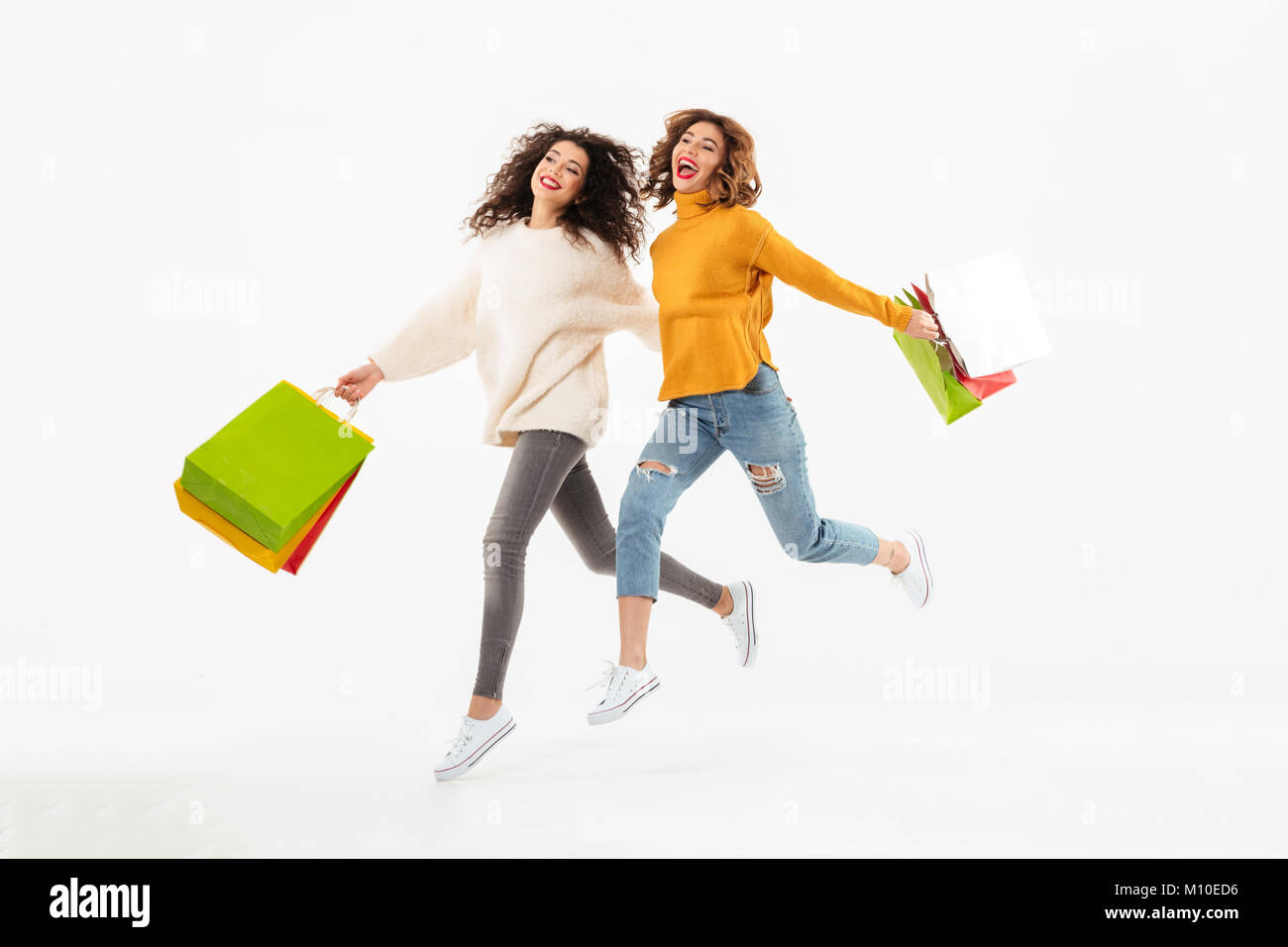 Two girls running away hi-res stock photography and images - Alamy
