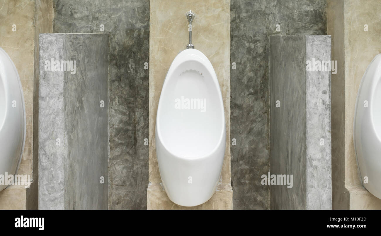 White urinal men with concrete wall loft style for interior design or ...